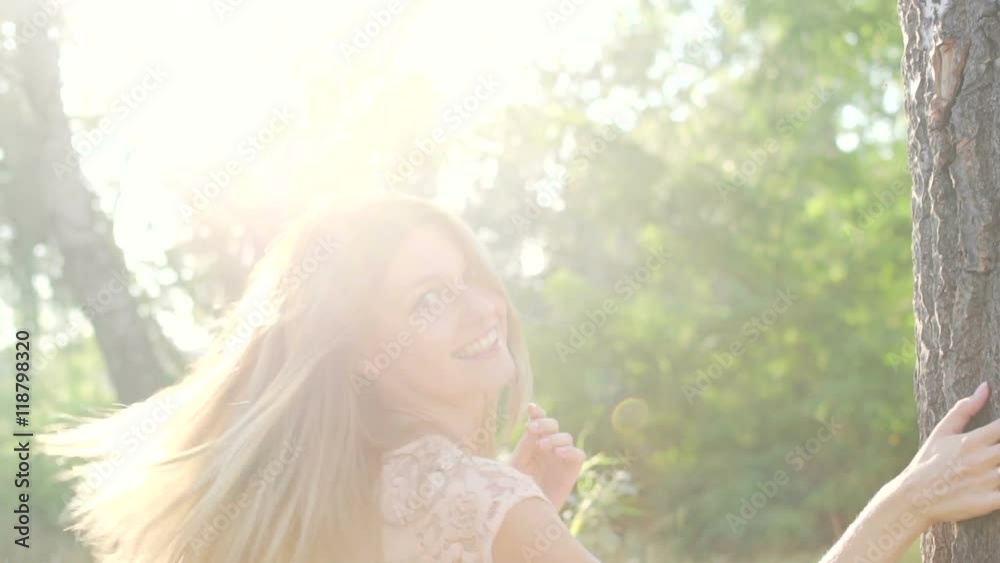 Attractive handsome girl running and hiding behind a tree Stock Video ...