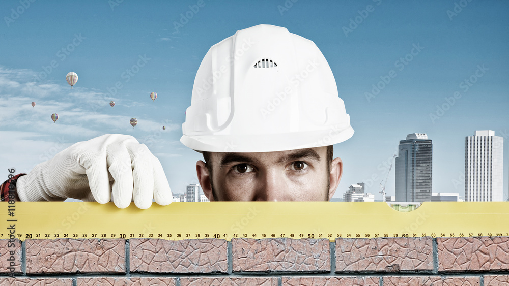Builder man with level . Mixed media Stock Photo | Adobe Stock