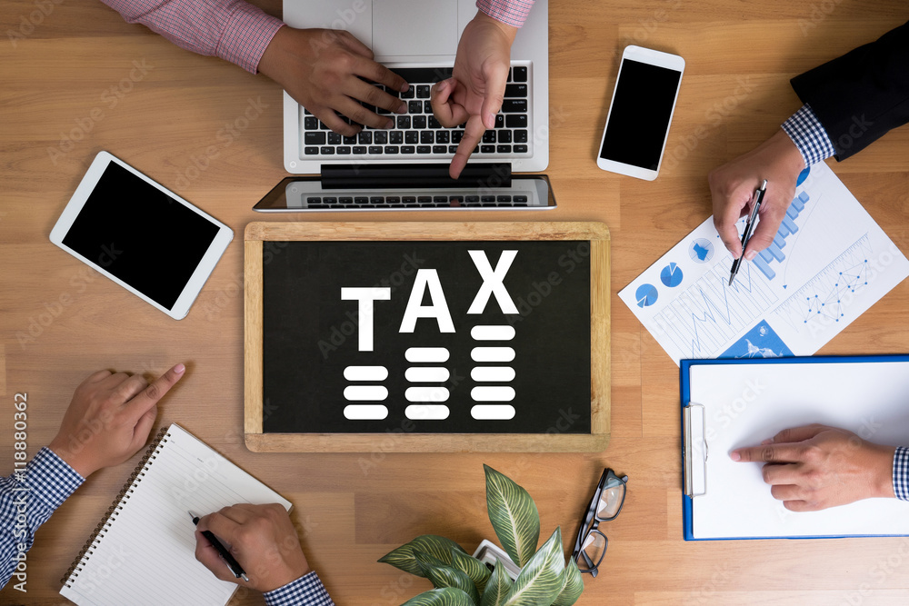 TAX TIME Business team hands at work with financial reports Stock-Foto | Adobe Stock