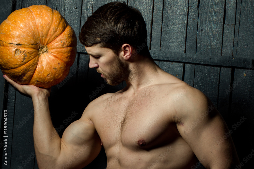 Muscular man with pumpkin Stock Photo | Adobe Stock