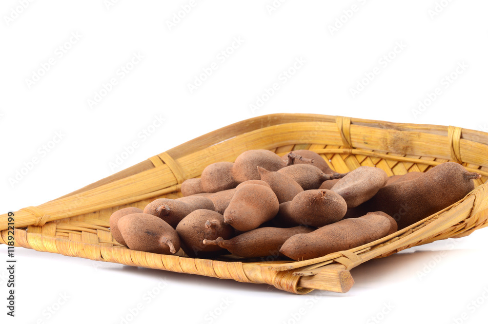 Tamarind isolated on white background in wooden basket. Sweet tamarind ...
