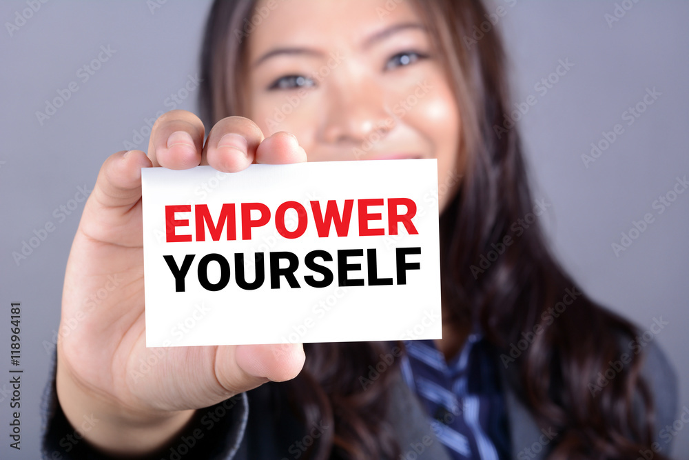 EMPOWER YOURSELF message on the card shown by a businesswoman Stock ...
