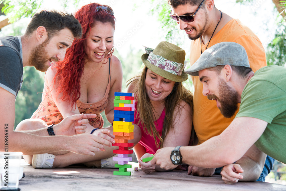Group of Friends Playing with a Skill Game Stock Photo | Adobe Stock