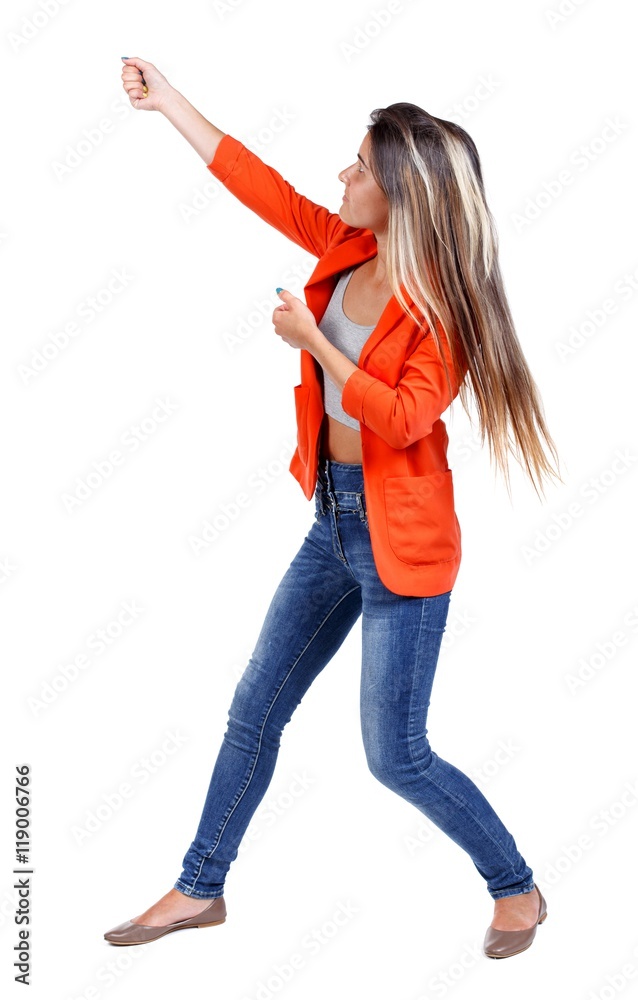 back view of standing girl pulling a rope from the top or cling to ...