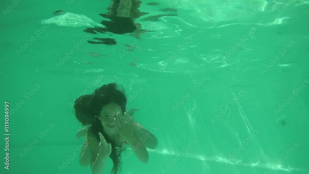 Girl diving in swimming pool Stock Video | Adobe Stock