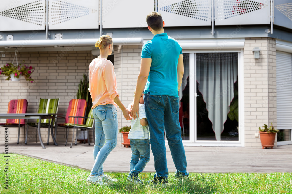 Family Standing In Front Of Their House Stock Photo | Adobe Stock