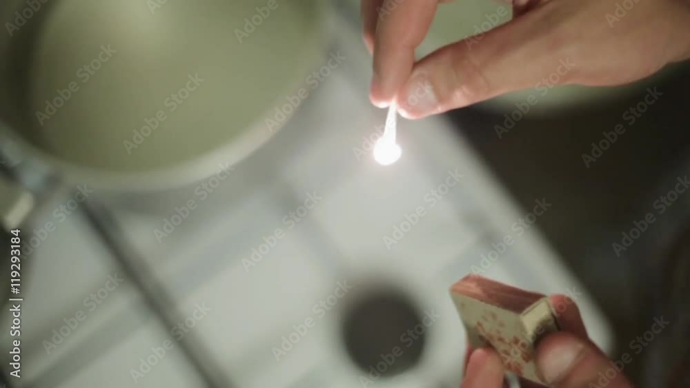 Man hands ignite match, hit on matchbox focus in. Ignition of white gas ...
