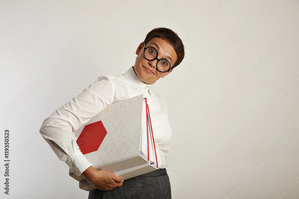 Surprised funny woman teacher looks at camera inquiringly and holds two ...