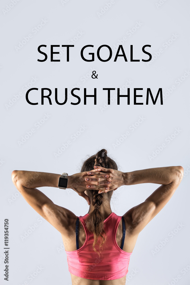 Back view of beautiful young person wearing red sportswear bra on grey ...