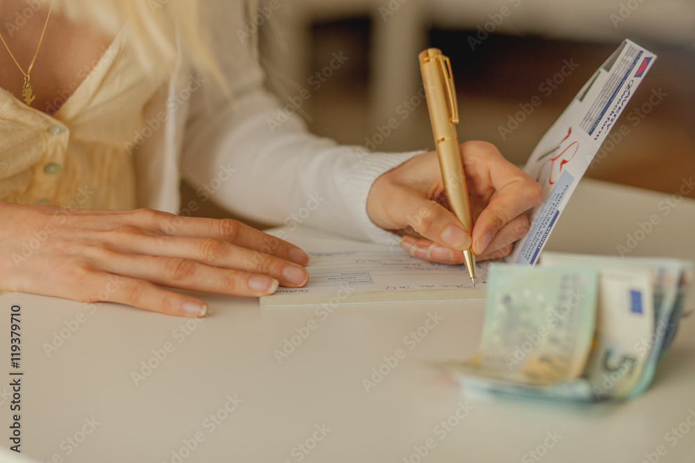 Signing a cheque Stock Photo | Adobe Stock