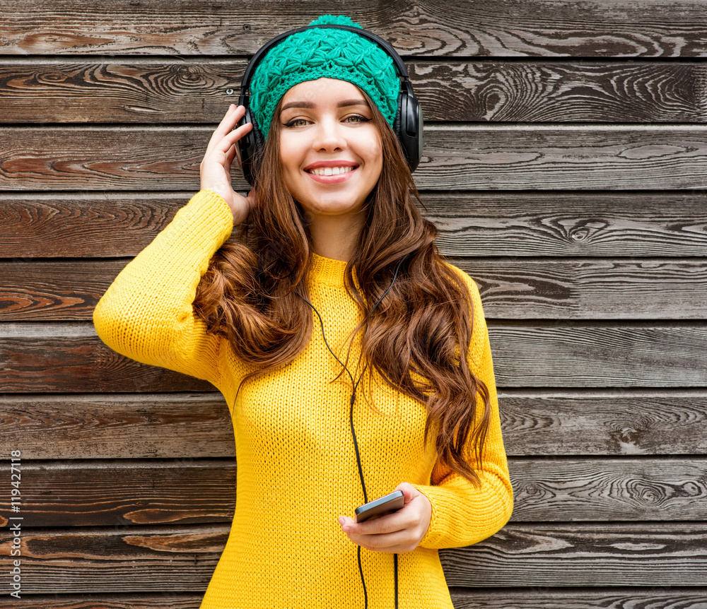 Cool girl having fun listens music in headphones over wooden bac Stock ...