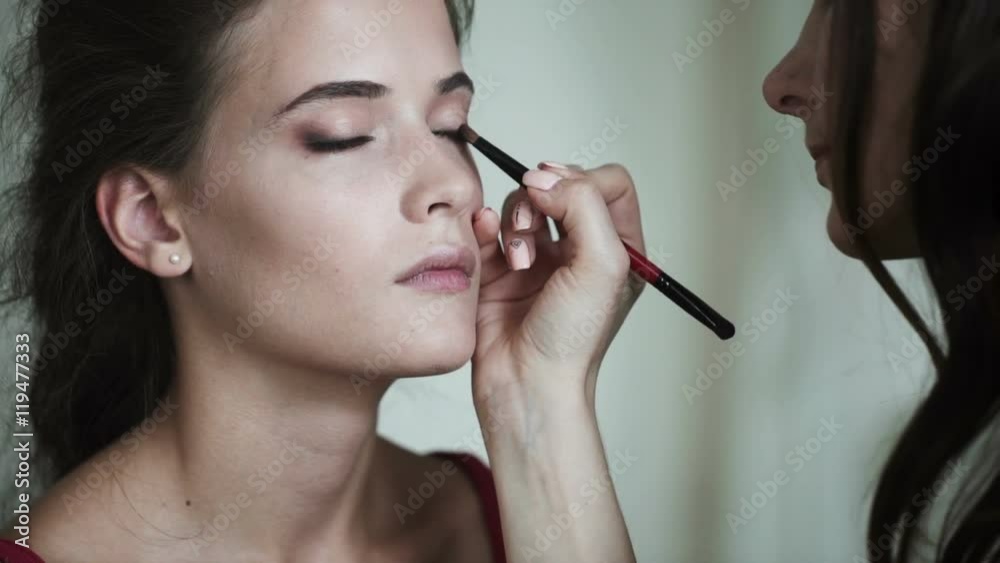 makeup artist makes models eye makeup Stock Video | Adobe Stock