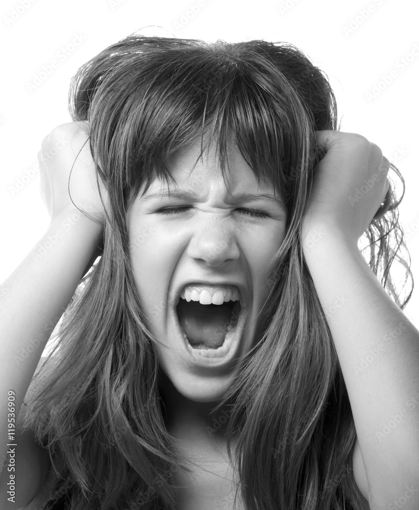 Foto Stock Portrait of angry spoiled teenage girl screaming isolated ...