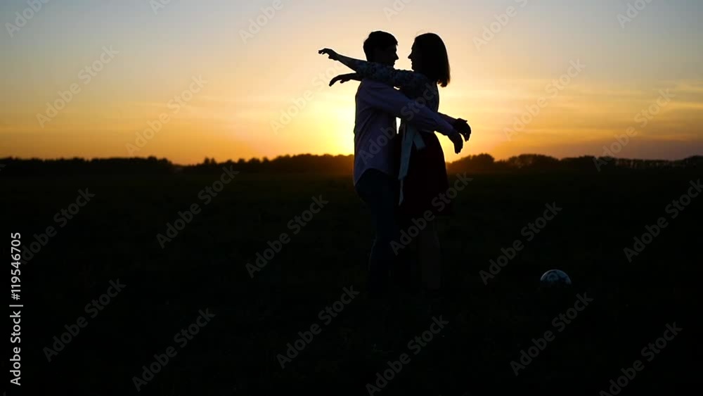 lovers guy with a girl hugging at sunset Stock Video | Adobe Stock