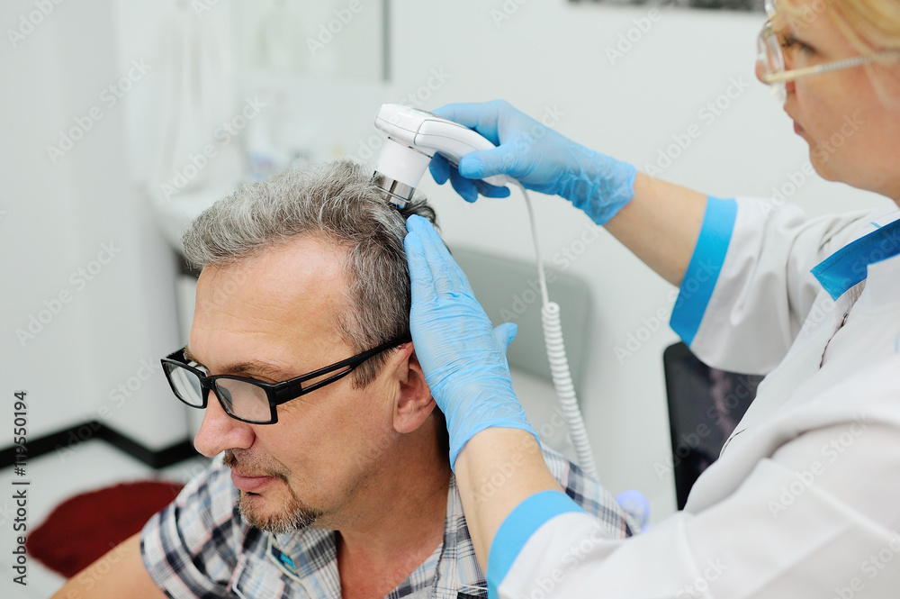 diagnostics hair and scalp. Trihoskopiya. Doctor examine patient male ...