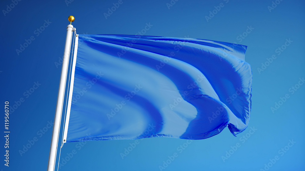 Light blue flag waving against clean blue sky, close up, isolated with ...