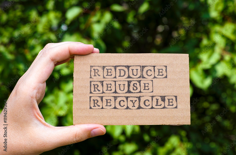 Woman hand holding cardboard card with words Reduce Reuse Recycle made ...