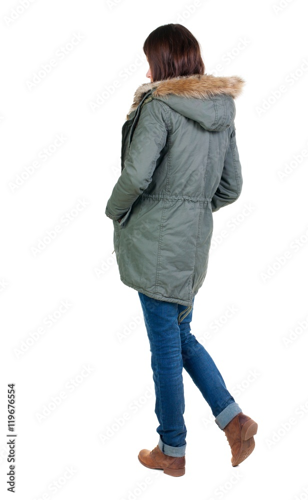 back view of standing young beautiful brunette woman in park. girl in ...