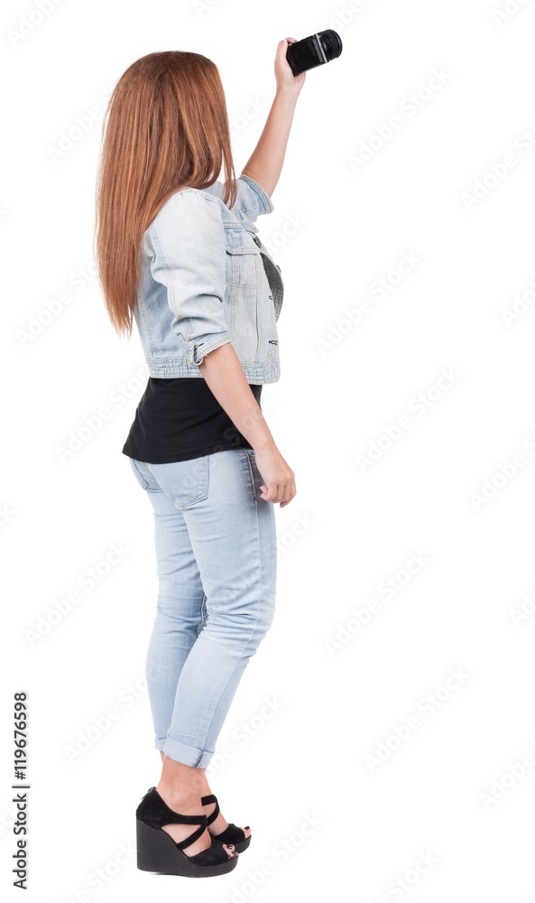 Back view of woman photographing. girl photographer in jeans. Rear view ...