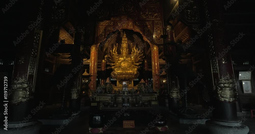 Temple interior and bronze statue of Quan Am Buddhist statue with altar ...