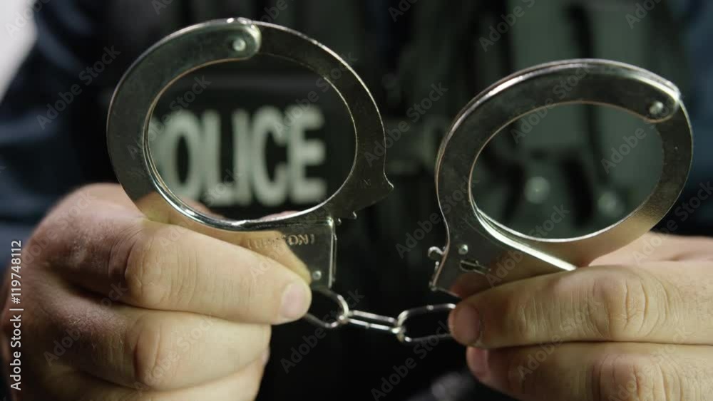 Vidéo Stock Police officer and handcuffs - tactical vest and tools for ...