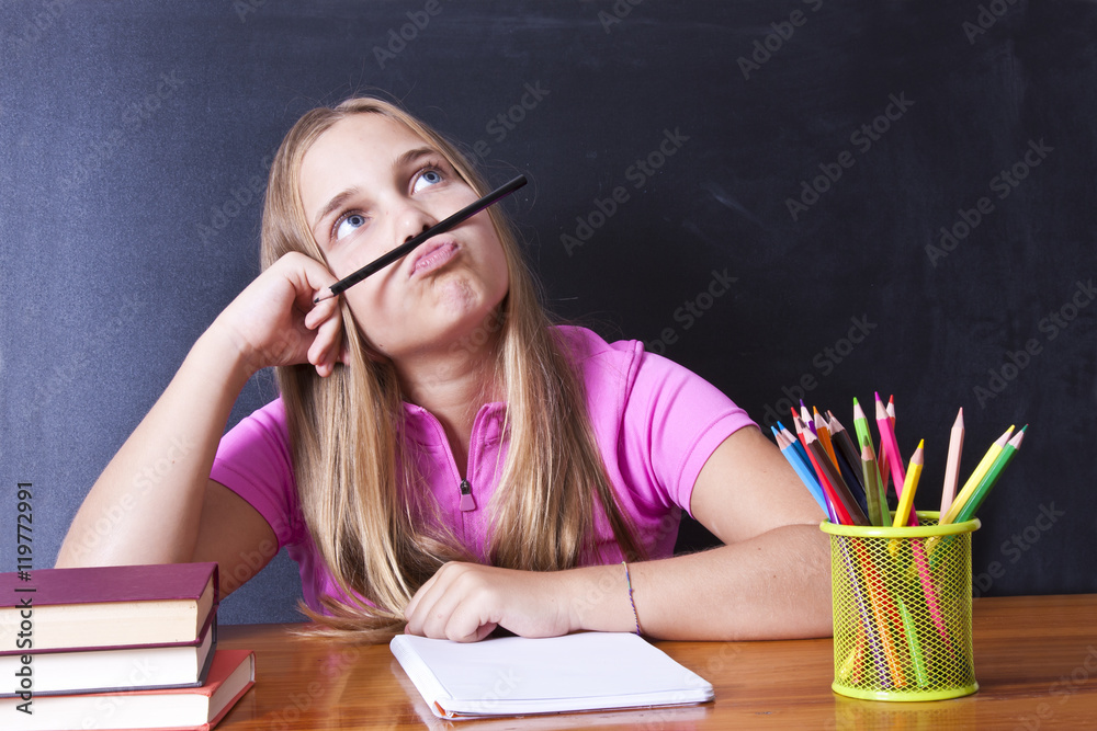 thinking girl at school on study table Stock Photo | Adobe Stock