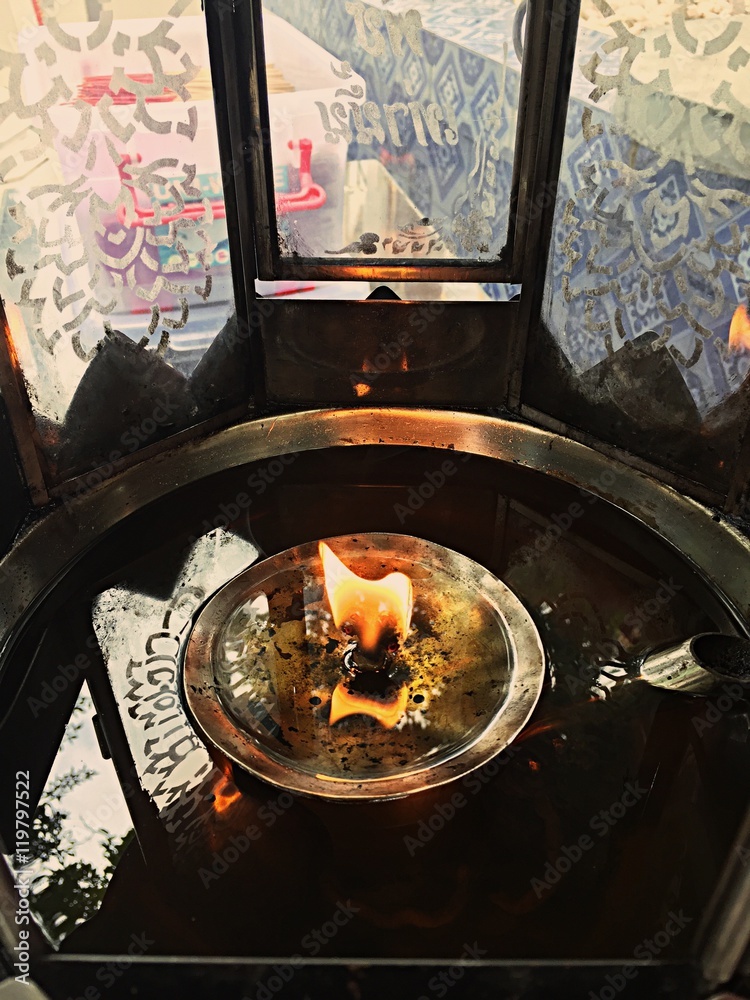 Candle and fire in glass lamp Stock Photo | Adobe Stock