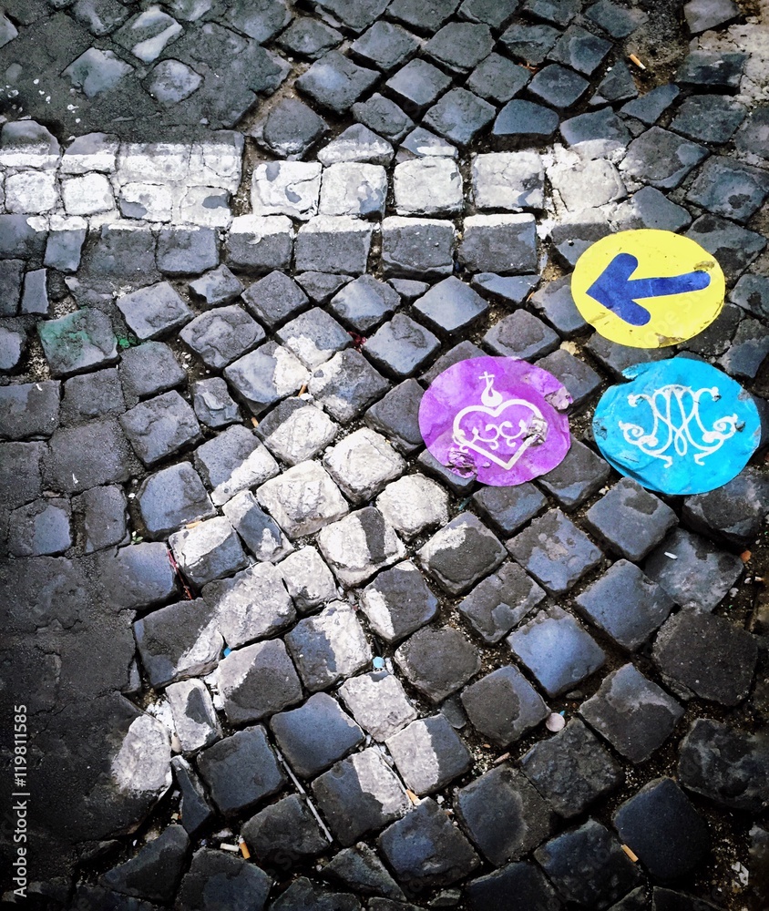 cobblestone road with colored indications Stock Photo | Adobe Stock