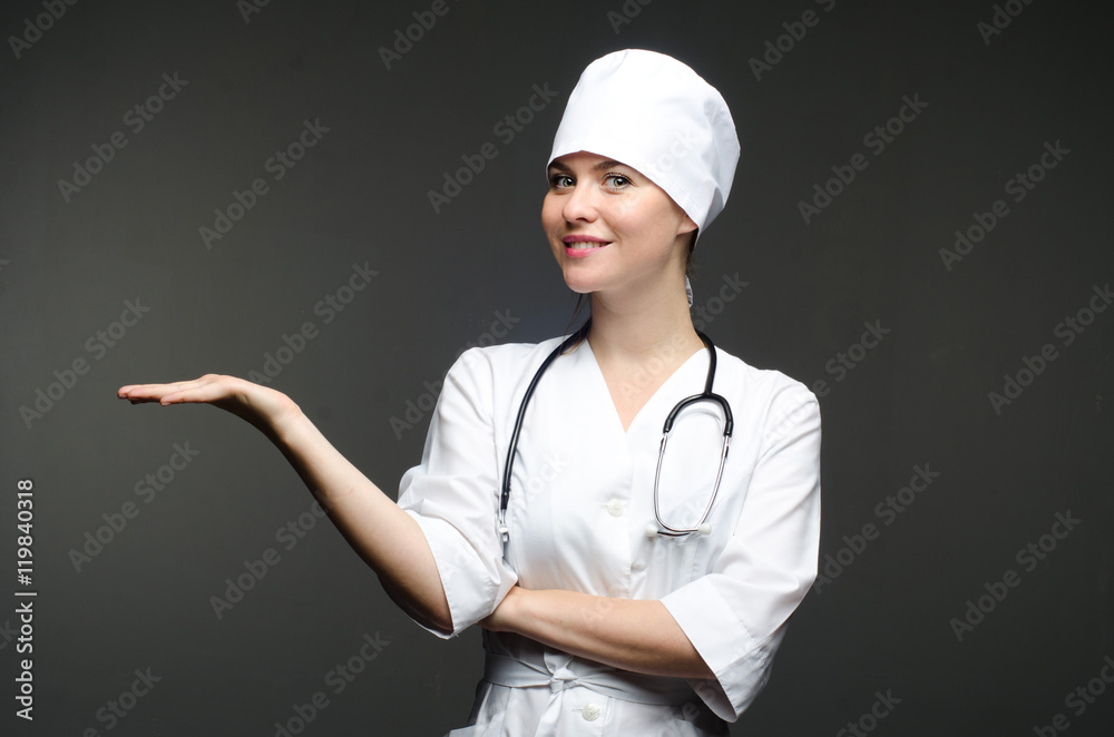 Doctor advertising your product. Beautiful female doctor showing blank ...