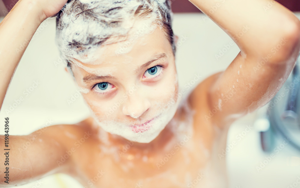 Cute young girl in shower washing hair and face with shampoo. Stock ...