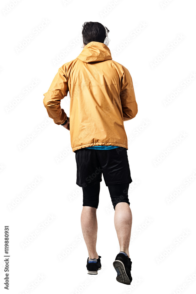 Back view of jogger in jacket running. Toned desaturated full body ...