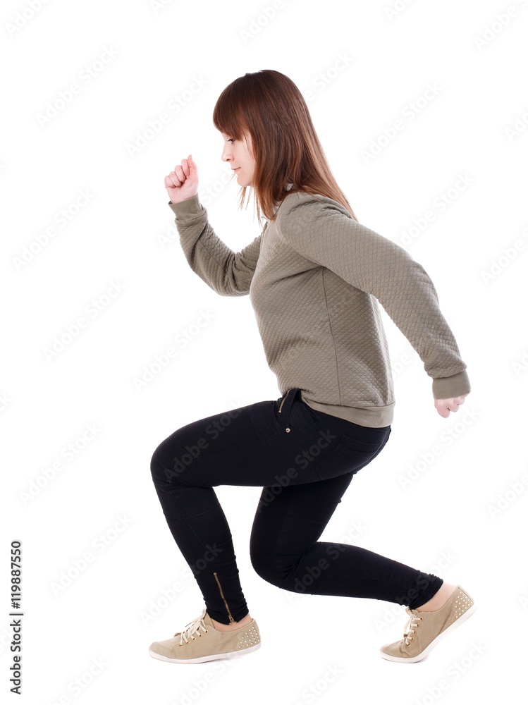 back view of standing young beautiful woman in jeans. backside view of ...