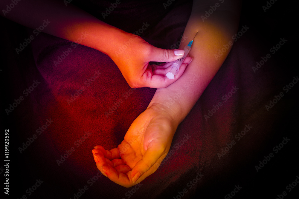 Stabbing drugs. the syringe and the hand enters injections, drugs ...