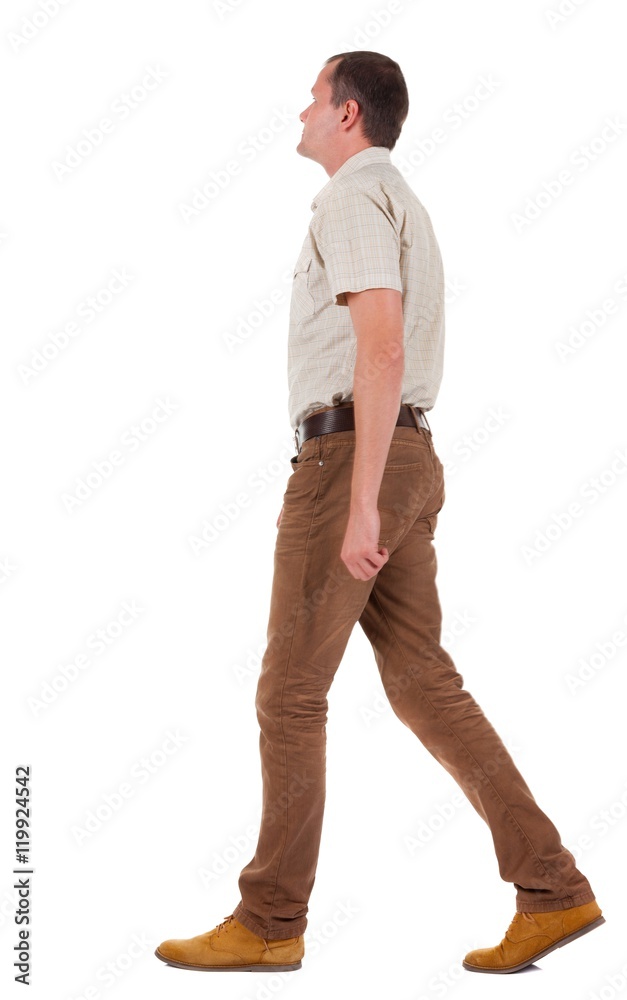 Back view of going handsome man in jeans and a shirt. walking young guy ...