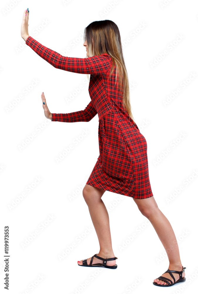 back view of woman pushes wall. backside view of person. The girl in ...