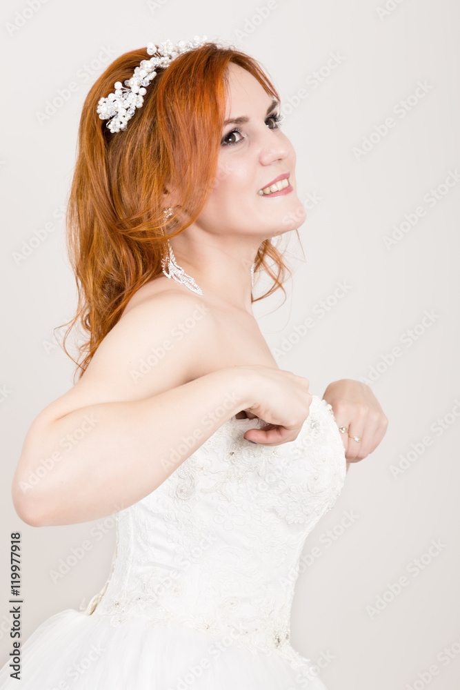 red-haired bride in a wedding dress, bright unusual appearance ...