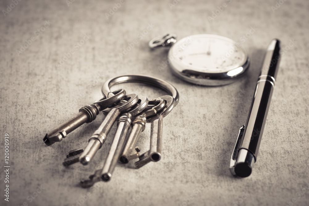 Vintage key set, pen and old watch on stone table. Symbol of nostalgia ...