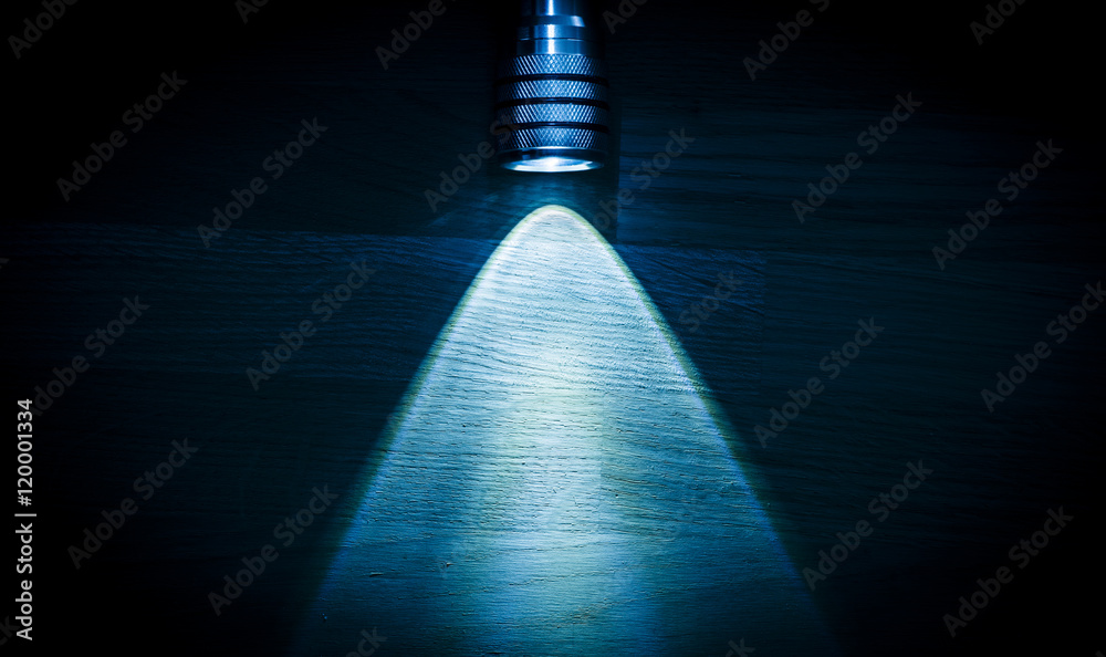 Flashlight and a beam of light in darkness. A modern led light with ...