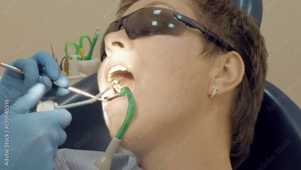 Woman at the dentist clinic office gets dental medical examination and ...