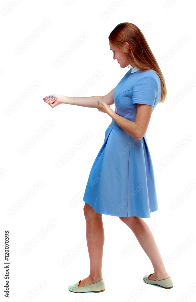 back view of standing girl pulling a rope from the top or cling to ...