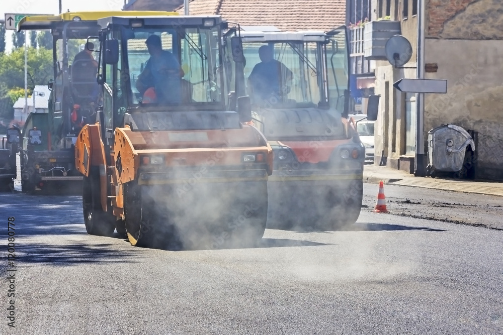 Roller compactor working on the new road construction site Stock Photo ...
