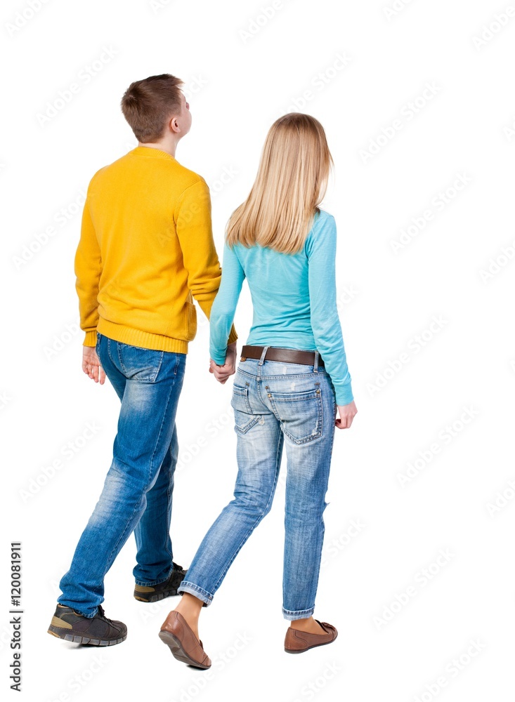 Back view going couple. walking friendly girl and guy holding hands ...