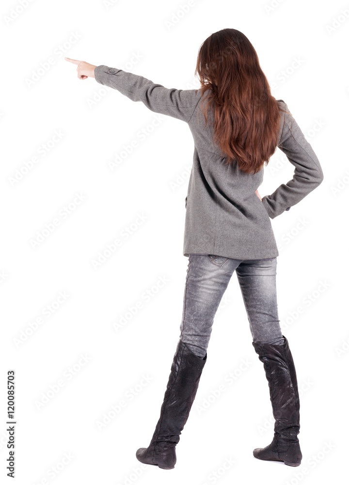 Back view of pointing woman. beautiful blonde girl in coat. Rear view ...