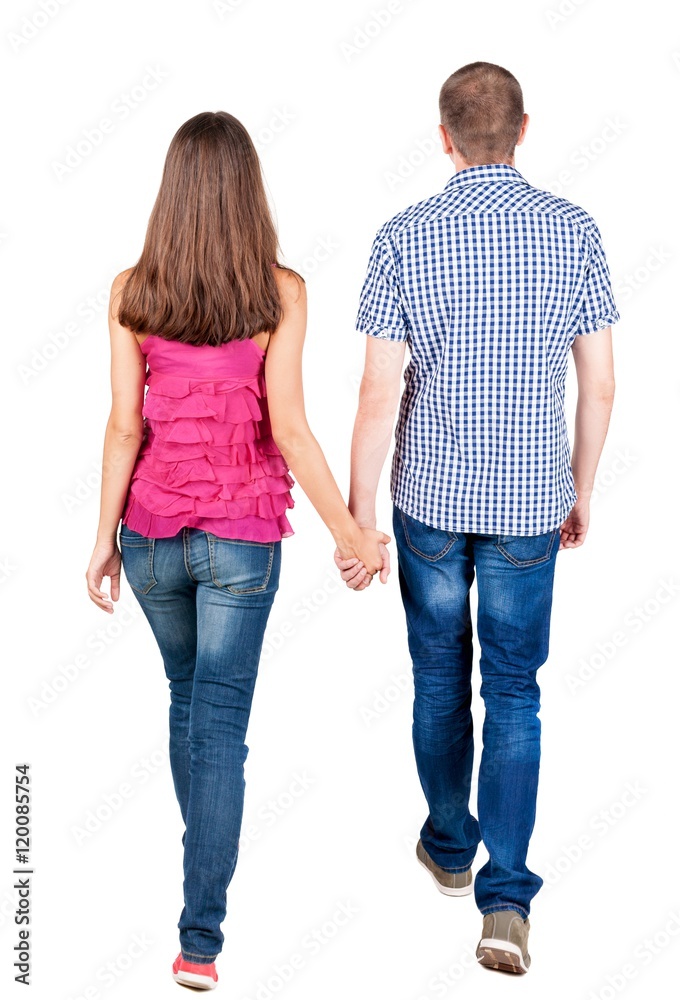 Back view of going young couple man and woman . walking beautiful ...