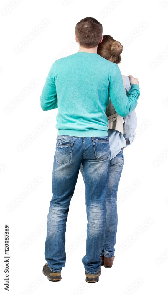 Back view of young embracing couple (man and woman) hug and look into ...