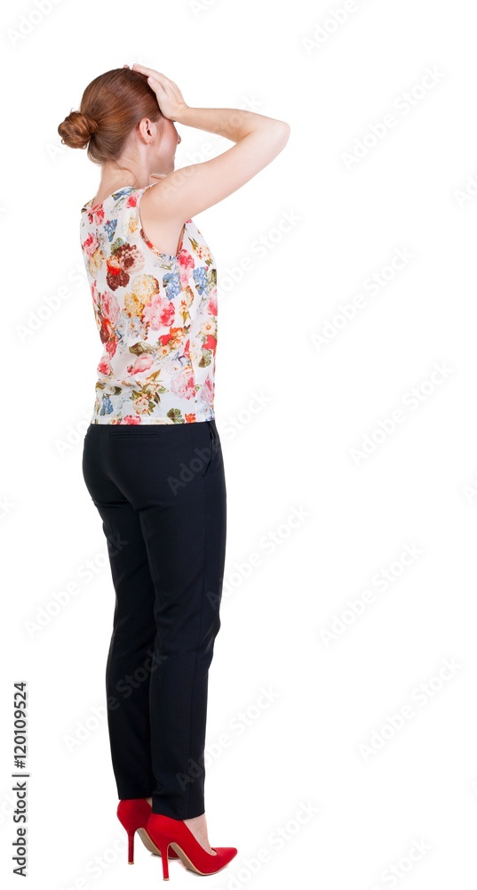 Back view of shocked woman. The girl put her head in her hands in ...