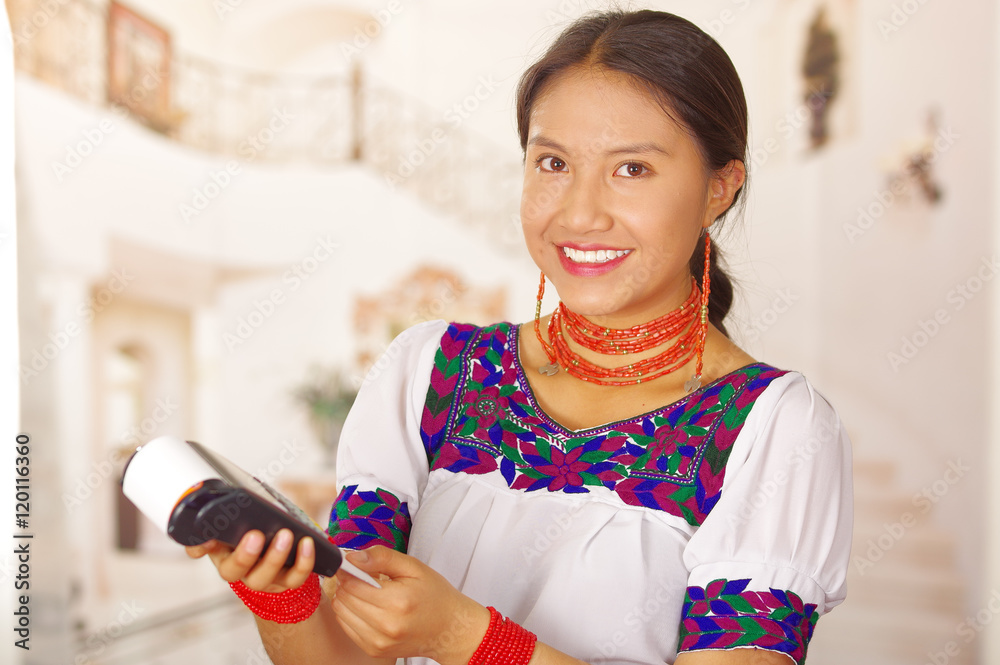 Young brunette wearing traditional native clothes working as hotel ...