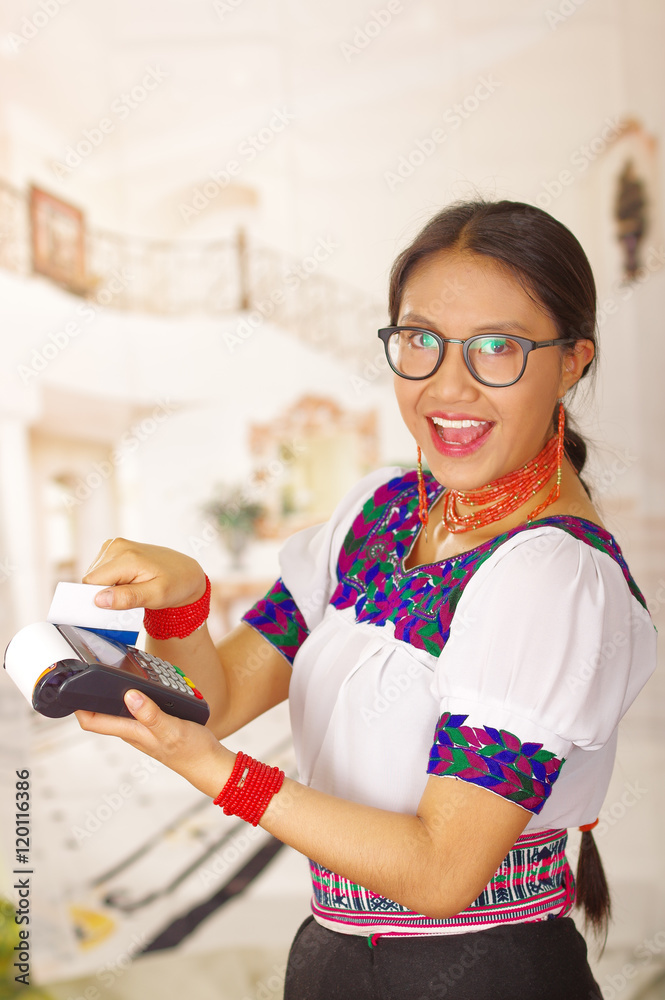 Young brunette wearing traditional native clothes working as hotel ...