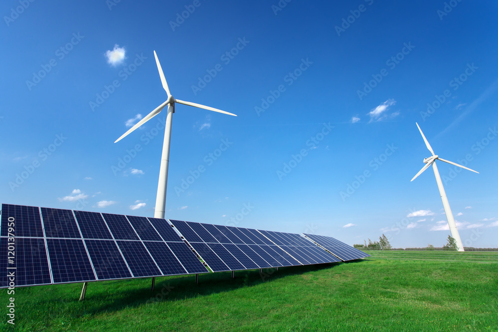 Windmill and solar panels on blue sky at daytime Stock Photo | Adobe Stock
