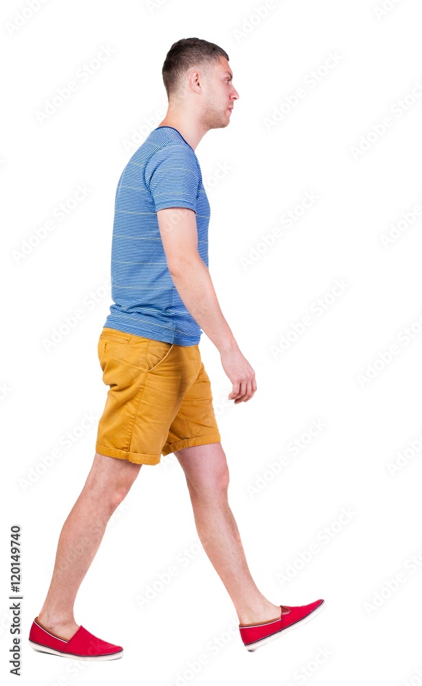 Back view of going handsome man in shorts. walking young guy . Rear ...